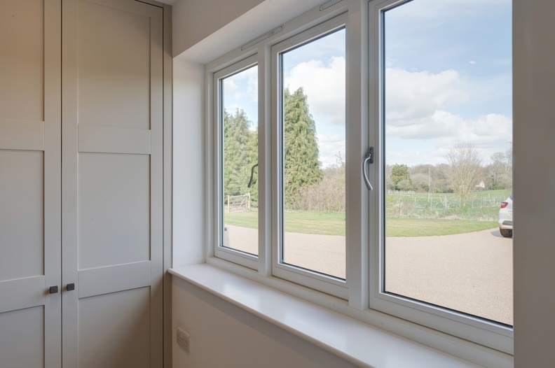 White casement windows with satin chrome classic collection hardware